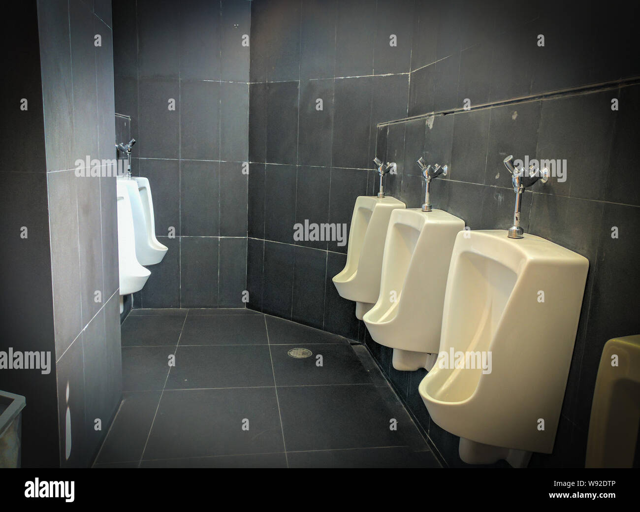 Modern urinal for male in a toilet Stock Photo - Alamy