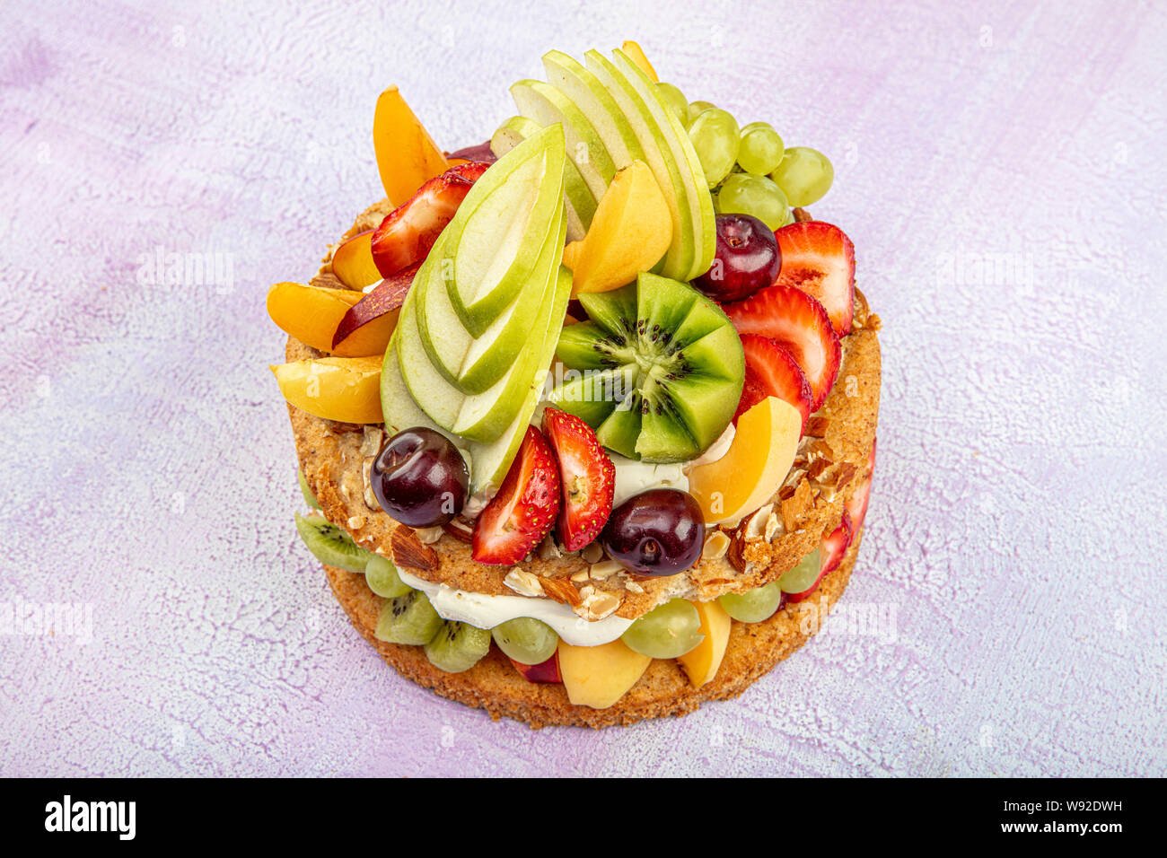 Mixed fruit cake, Fruits pastry pink wooden background Stock Photo - Alamy