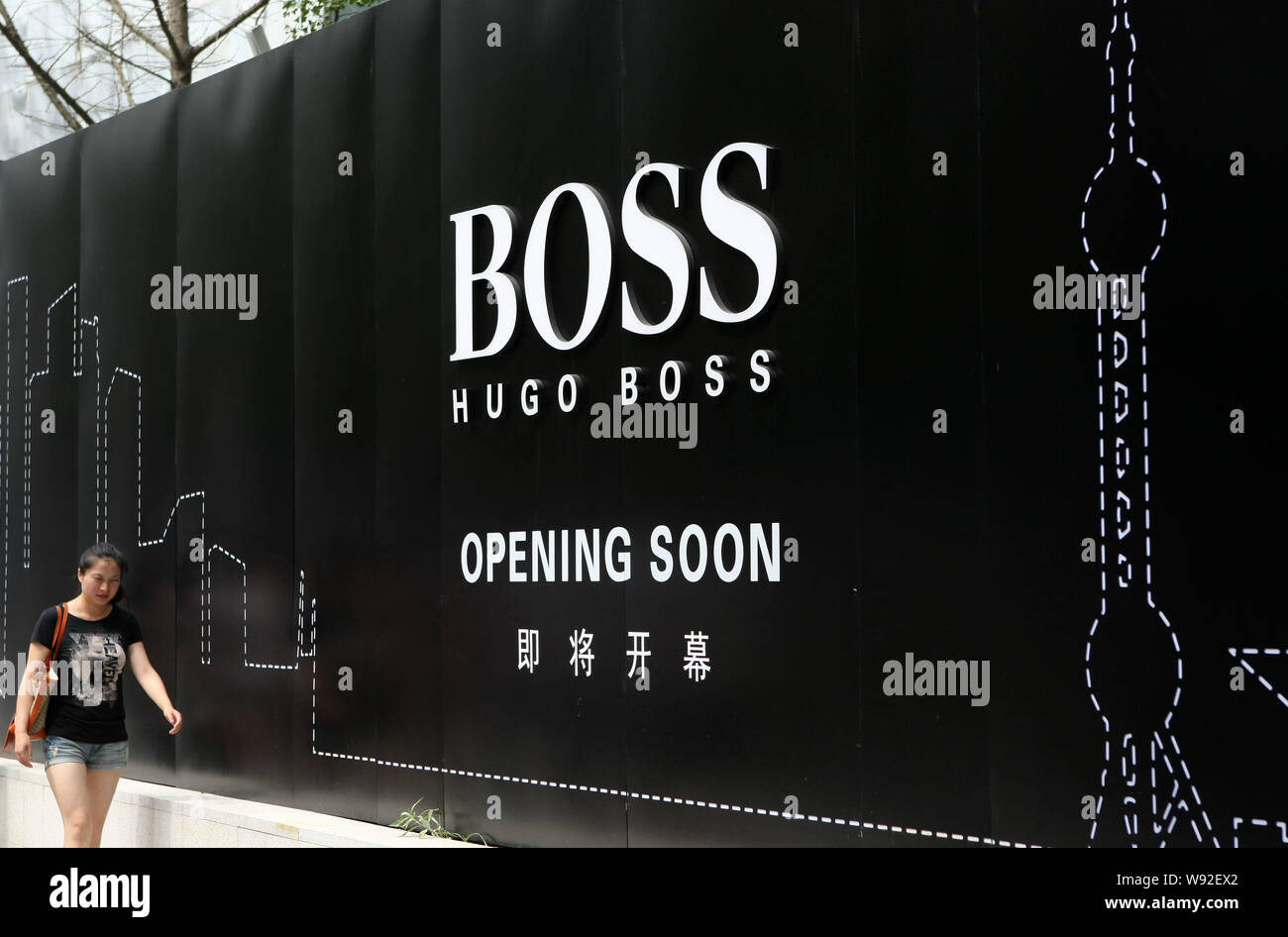 --FILE--A pedestrian walks past a new Hugo Boss shop under preparation ...