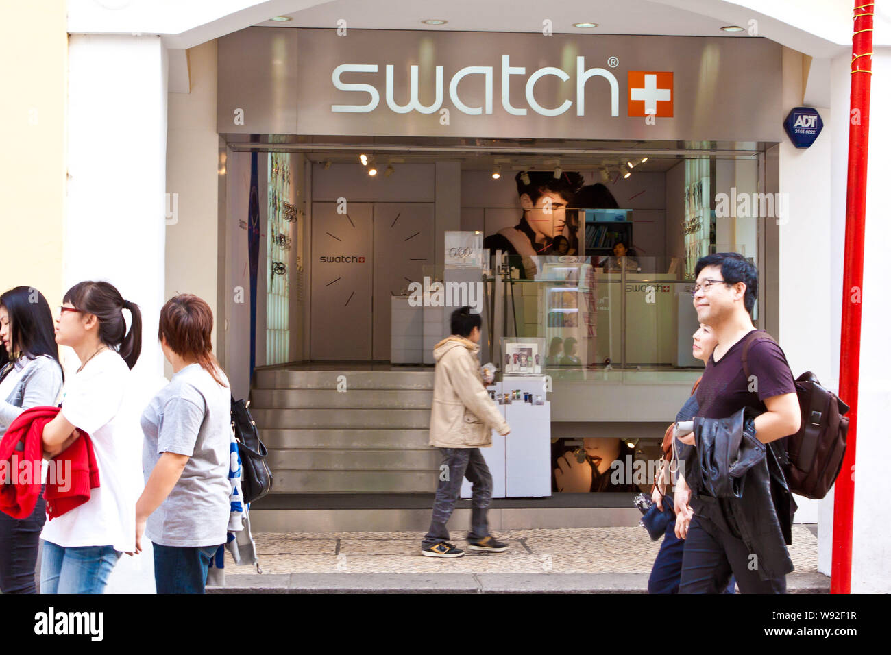 --FILE--Pedestians walk past a watch store of Swatch in Macau, China, 7 ...