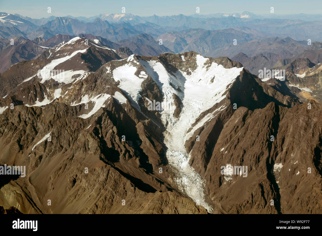 Andean mountain range with mountains peaks covered under snow, aerial ...