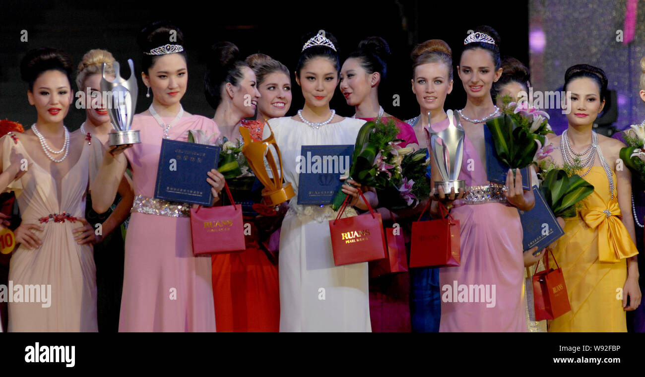 Models pose with their awards after the final stage of the 8th Asian ...