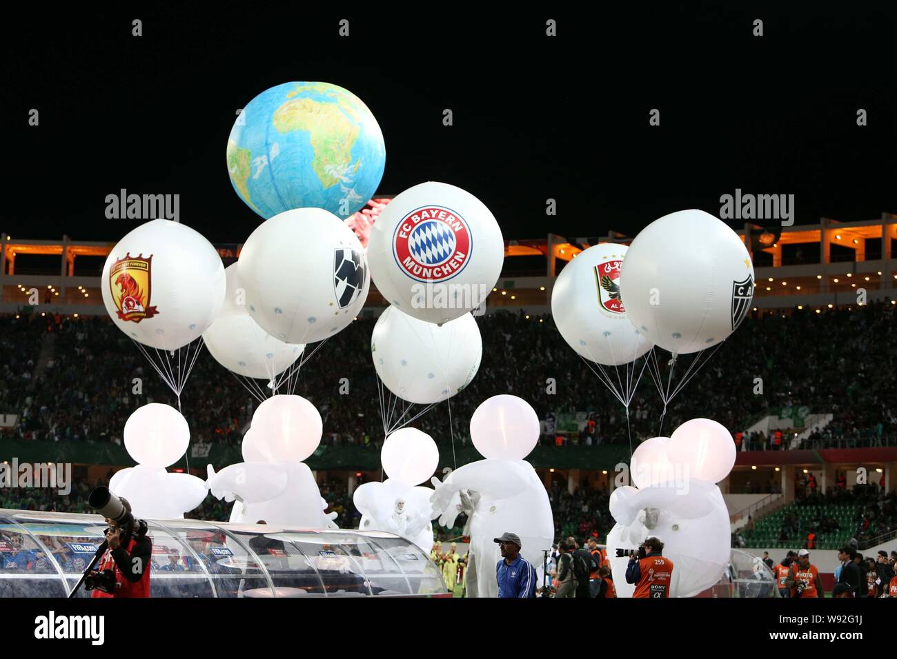 Entertainers hold balloons with the logos of football clubs at the ...