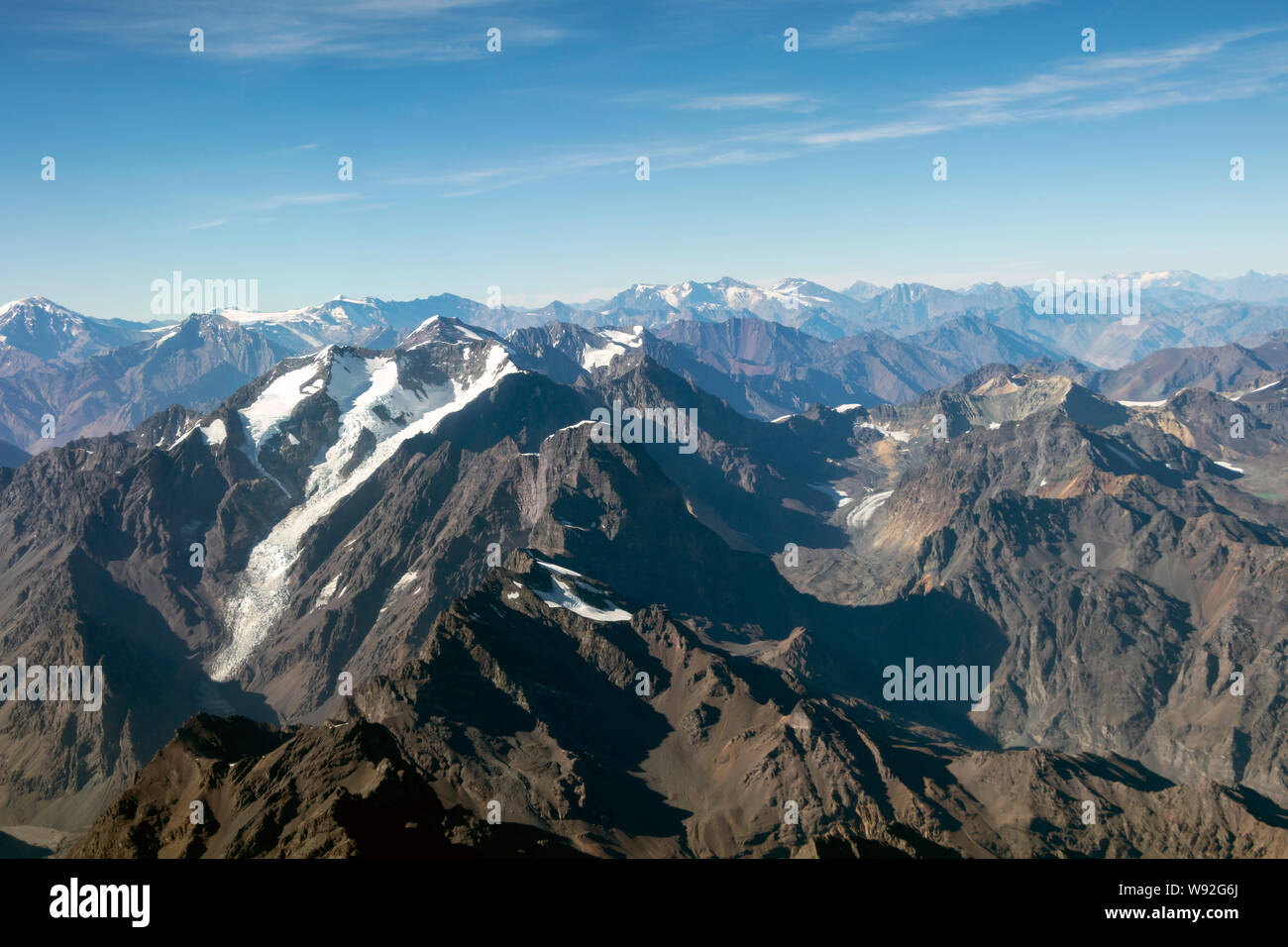 Andean mountain range with mountains peaks covered under snow, aerial ...