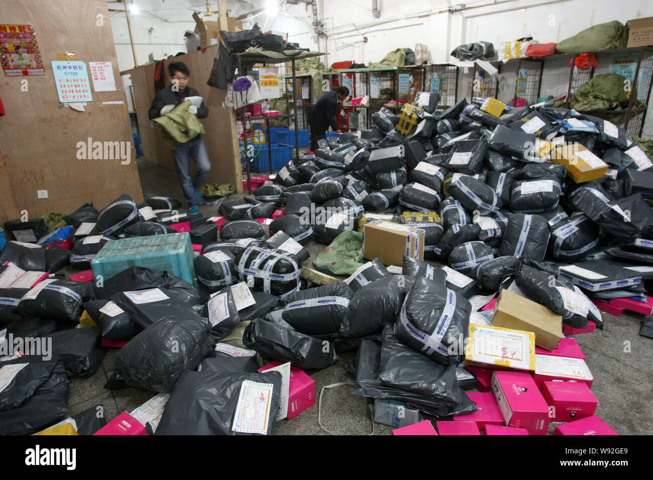 Chinese workers sort parcels, most of which come from online shopping ...