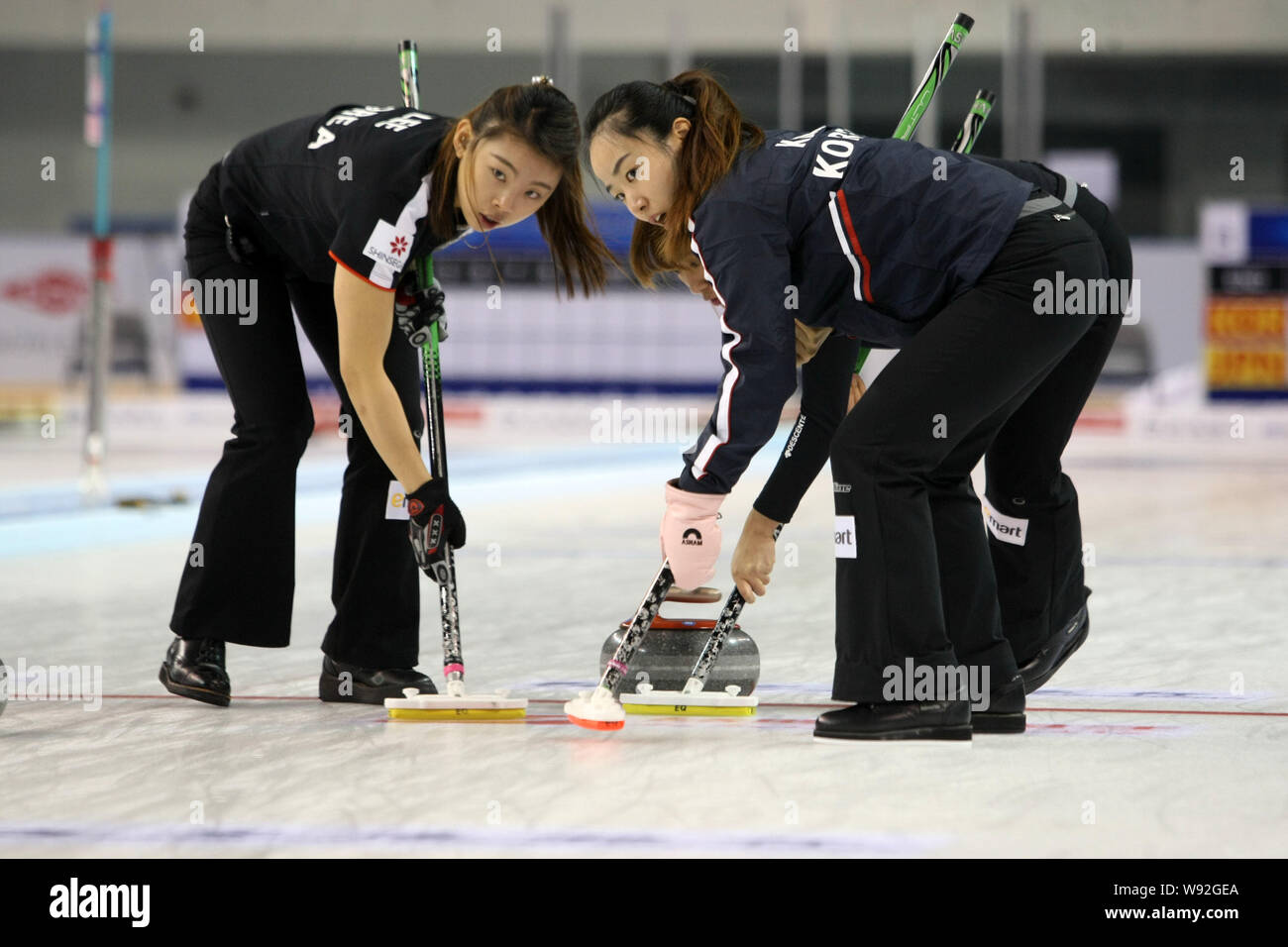 Lee Seul-bee, left, Kim Ji-sun, front right, and Gim Un-chi of South Korea sweep in the womens ...
