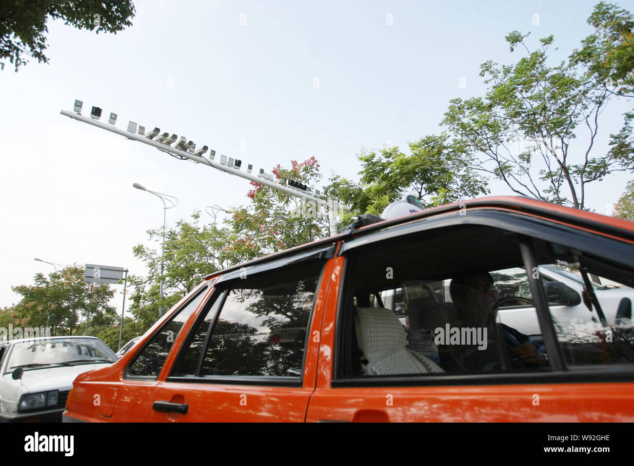 Cars pass under dozens of surveillance cameras and flashes installed on ...