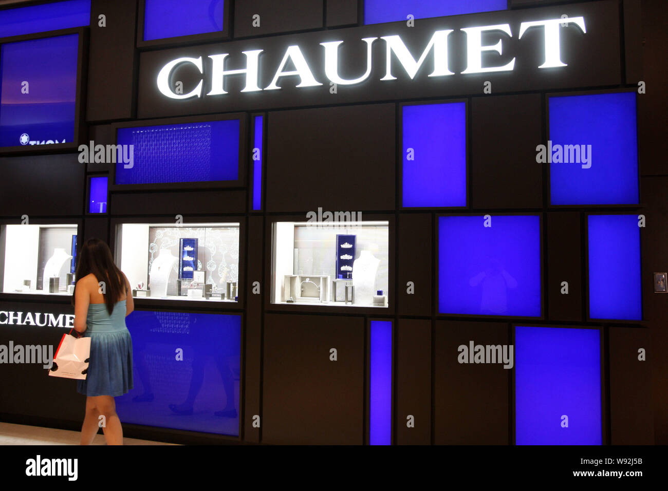A Chinese shopper walks past a store of luxury brand Chaumet in ...