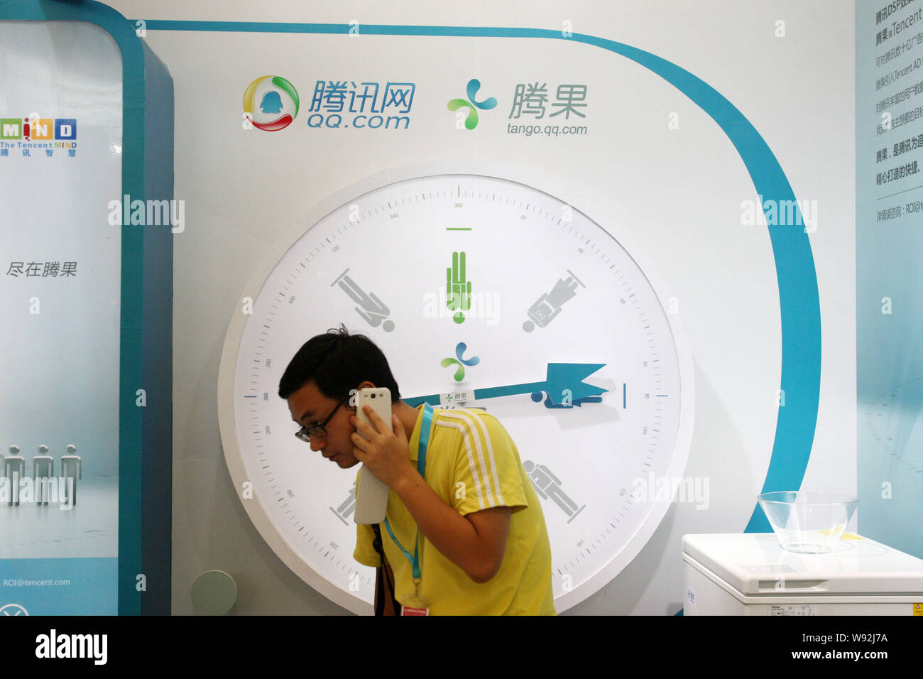 --FILE--A Chinese employee makes a phone call at the stand of QQ.com ...