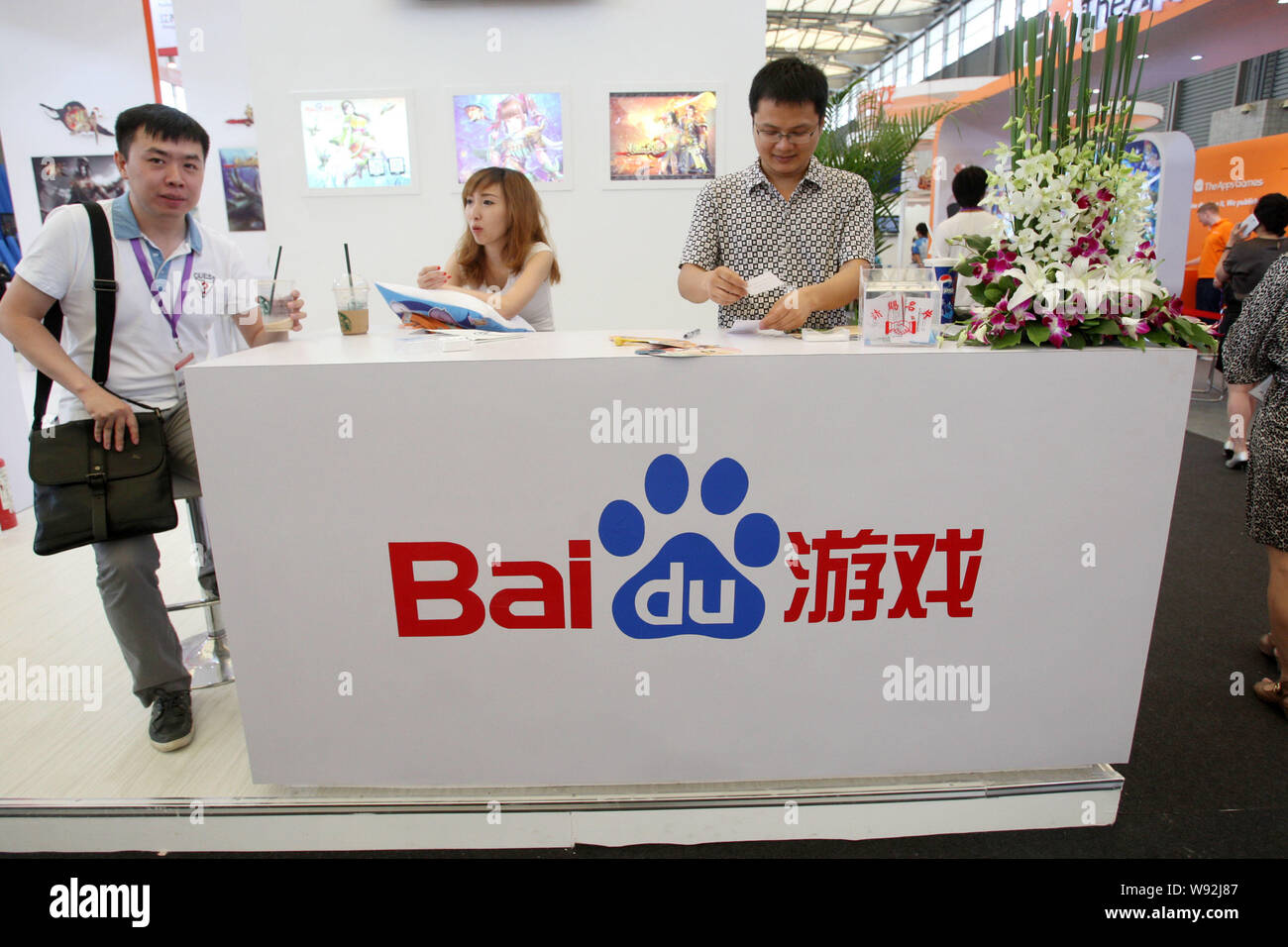 --FILE--Employees are seen at the stand of Baidu, a Chinese Internet ...