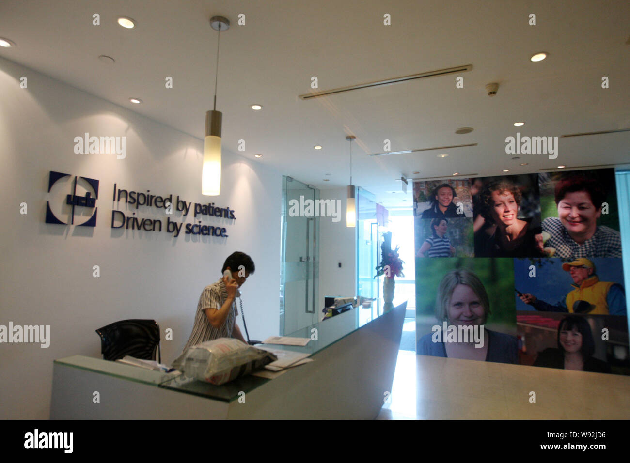 An employee talks on the phone at the front desk in the office of UCB ...