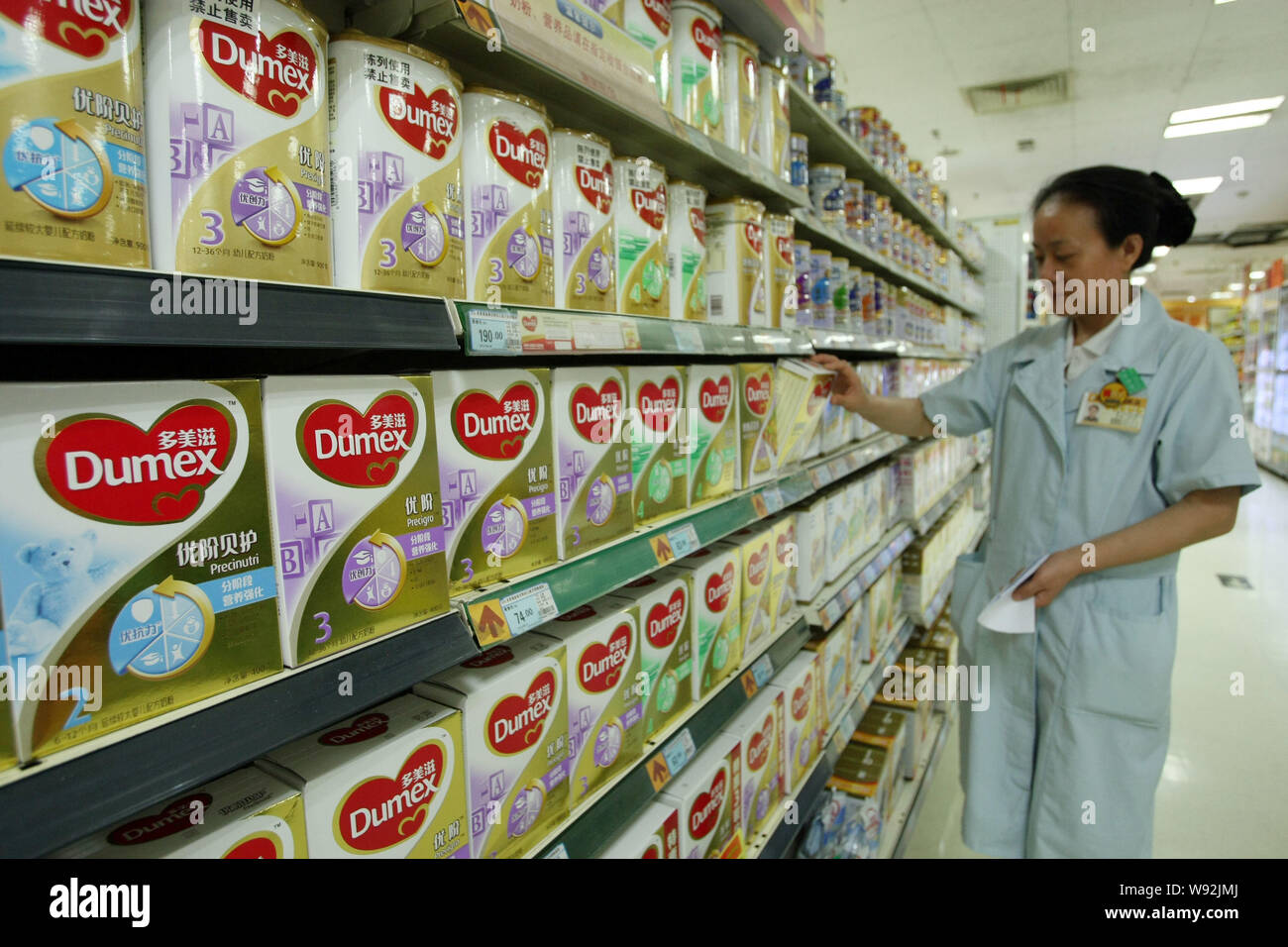 A Chinese employee puts boxes of Dumex baby formula of Danone on the ...