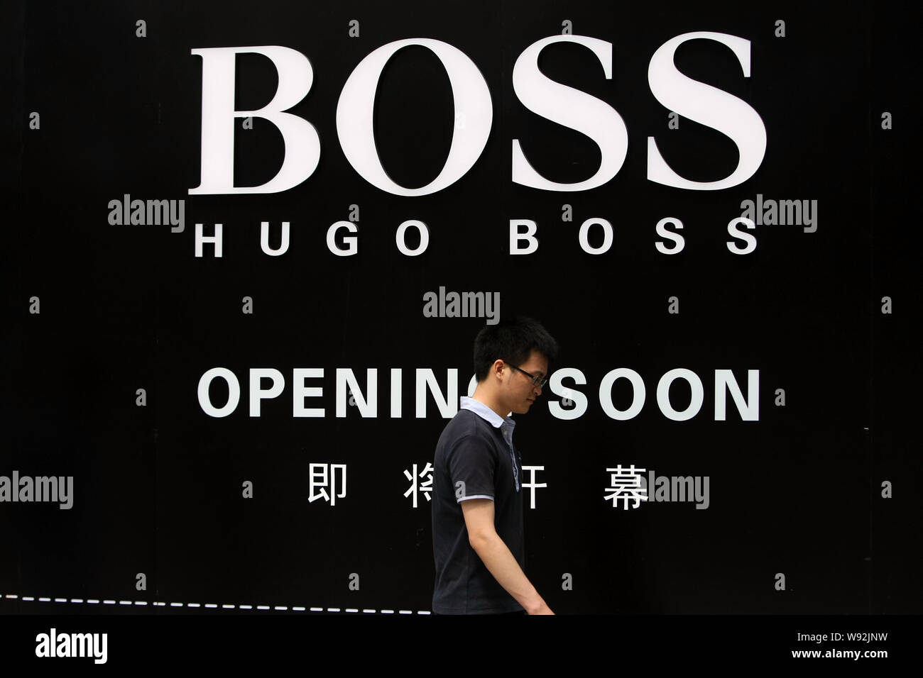 --FILE--A pedestrian walks past a new Hugo Boss shop under preparation ...