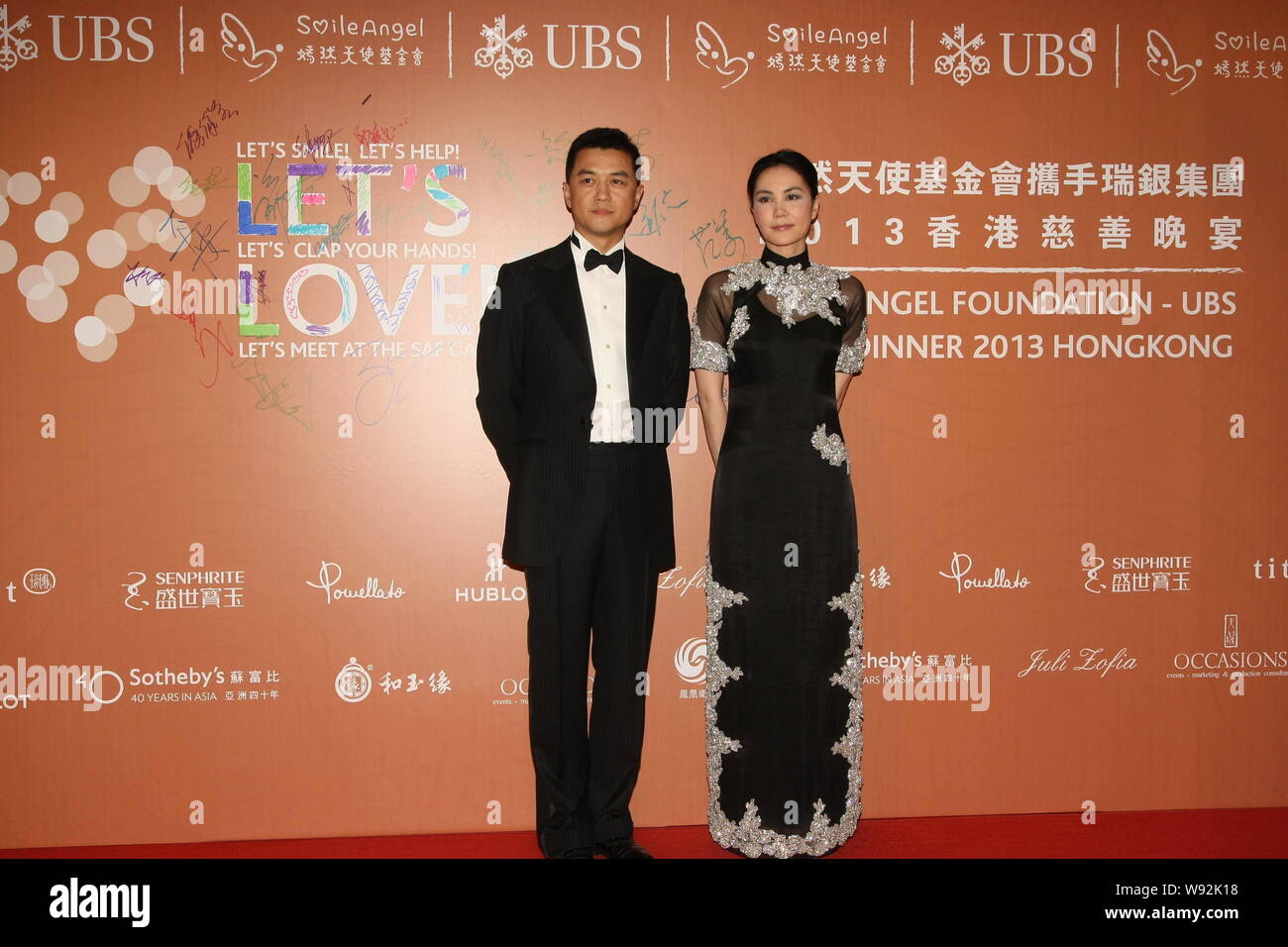 --FILE--Chinese pop diva Faye Wong, right, and her former husband, actor Li Yapeng, pose as they ...
