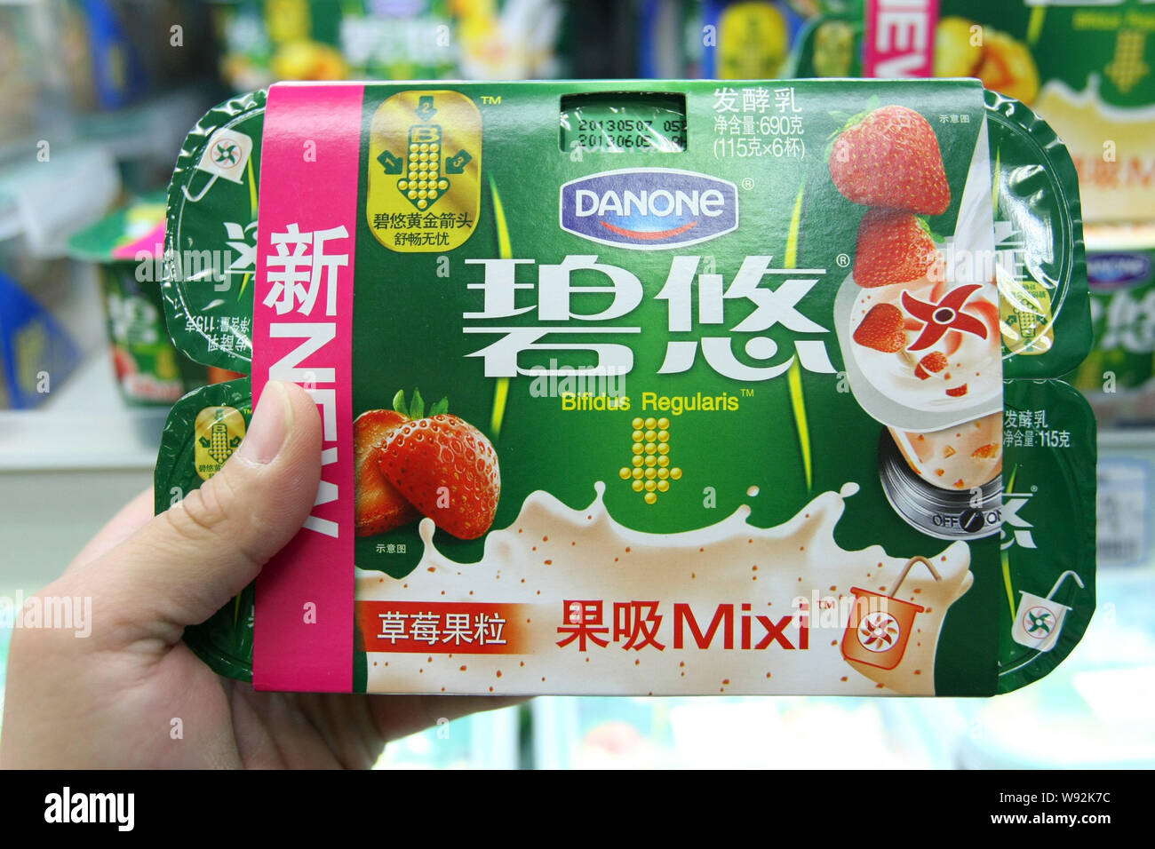 --FILE--A customer shops for Danone yoghurt at a supermarket in ...