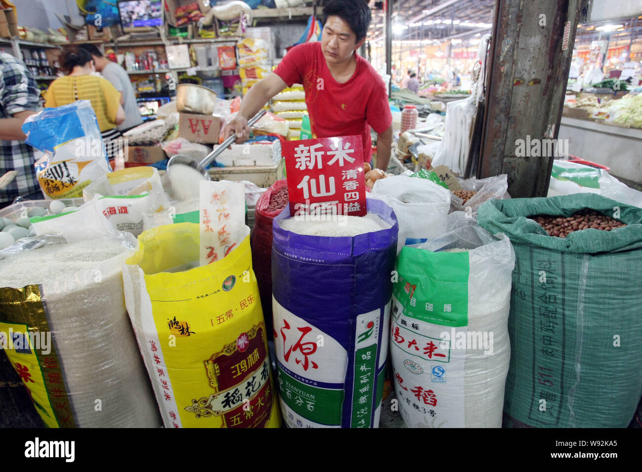 --FILE--A vendor sells rice at a market in Shanghai, China, 21 May 2013 ...