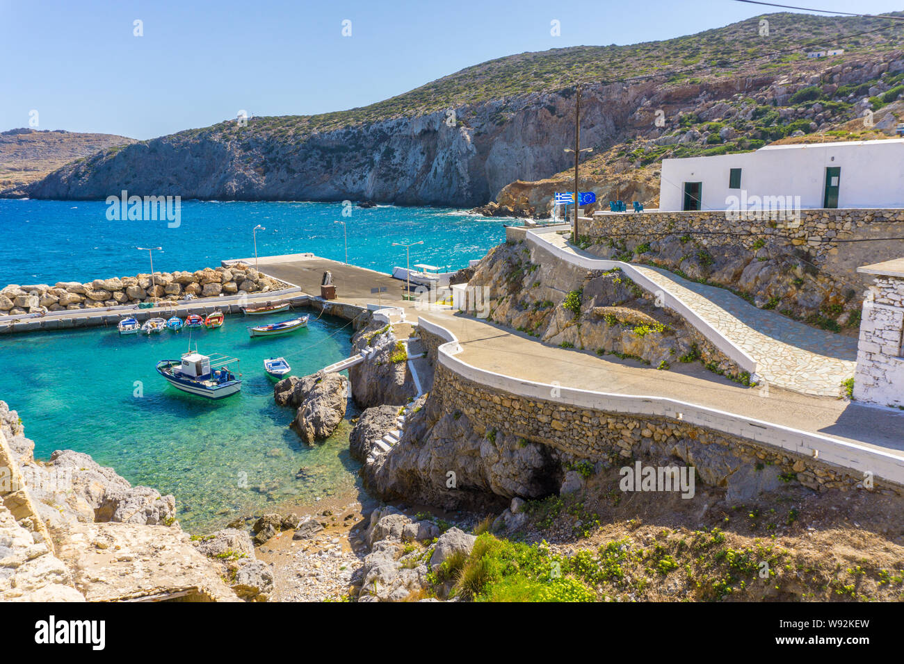 Potamos village with the port and the colorful fishing boats sailing in ...