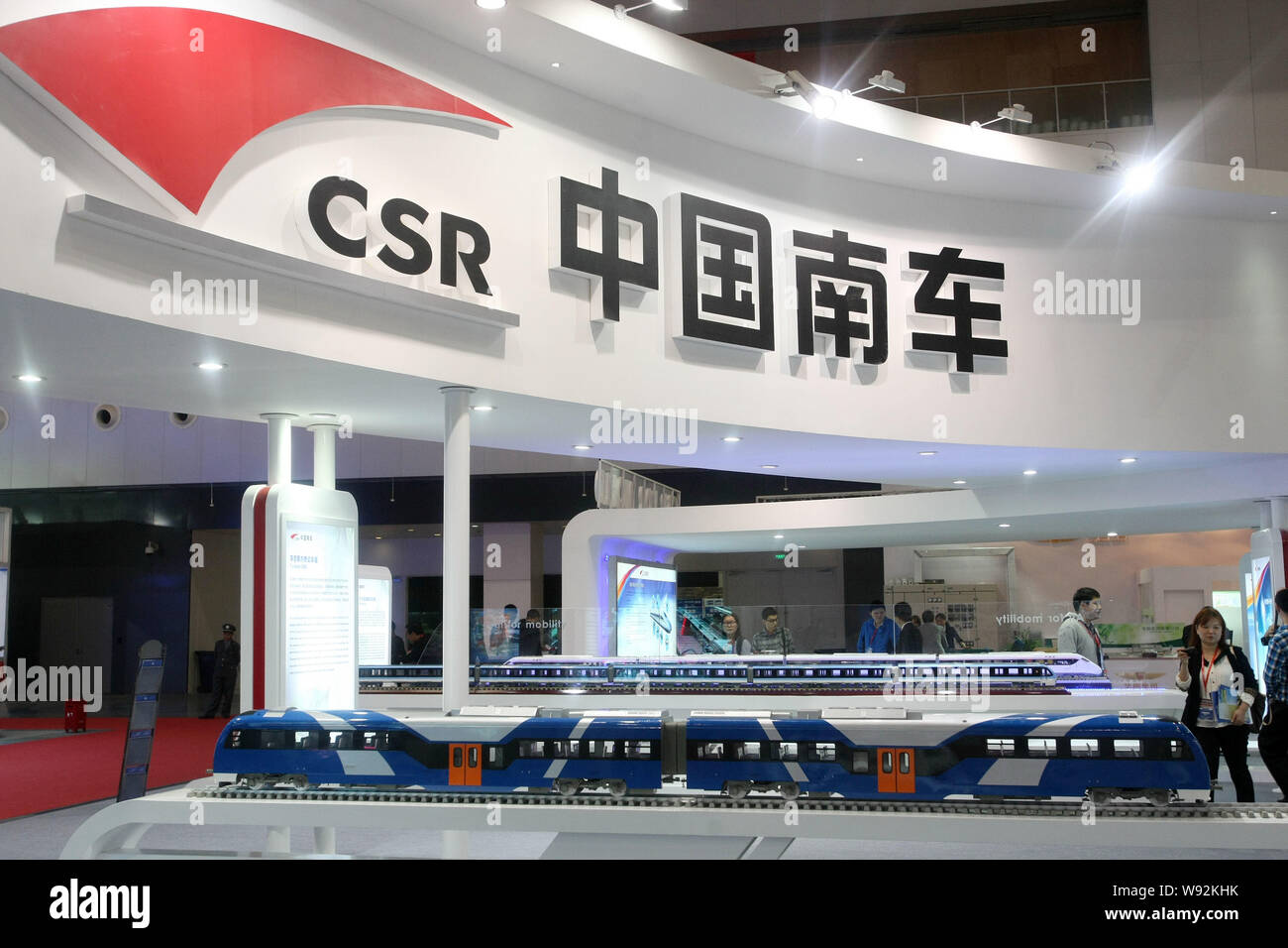 Visitors look at models of CRH trains at the stand of CSR (China South ...