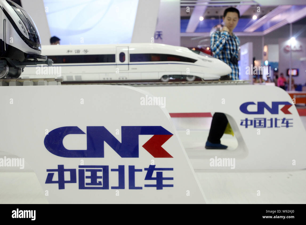 A visitor looks at models of CRH trains at the stand of CNR £¨China ...
