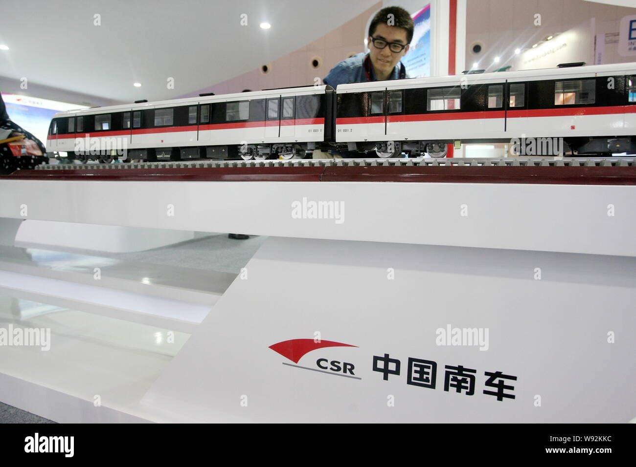 --FILE--A visitor looks at a model of a CRH train at the stand of CSR ...