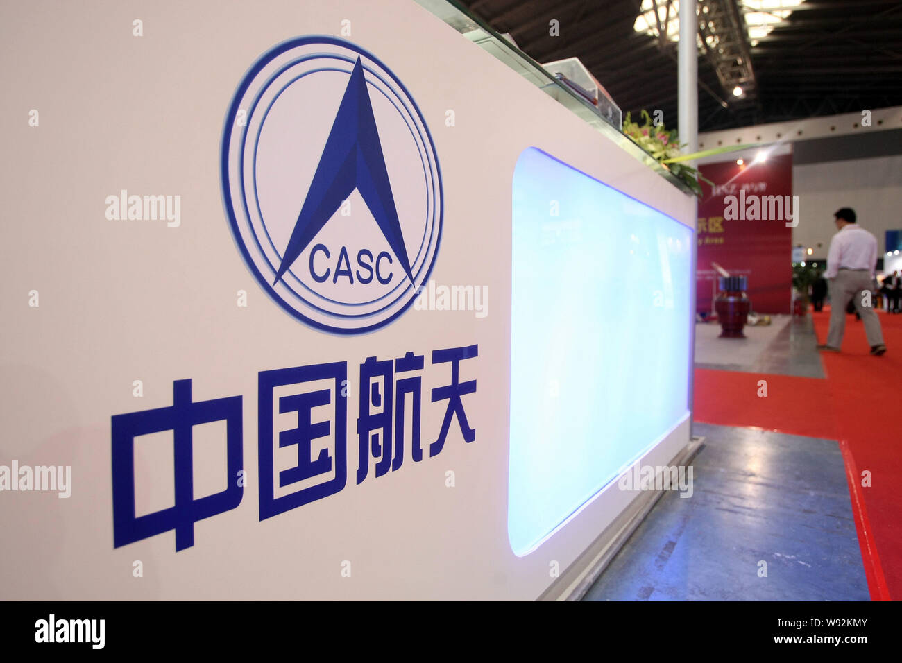 A visitor walks past the stand of the China Aerospace Science and ...