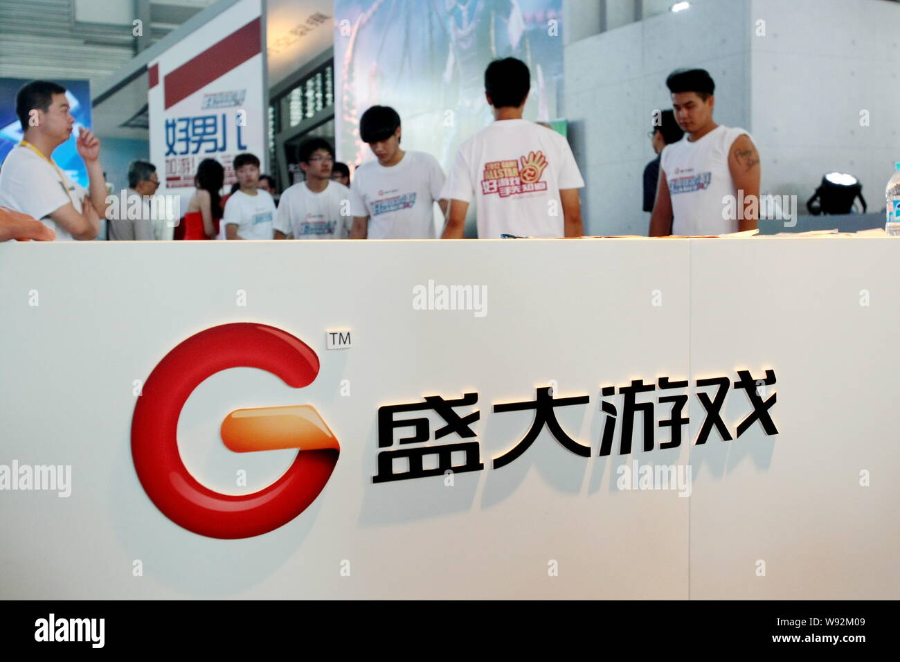 --FILE--Employees are seen at the stand of Shanda Games during the 10th ...