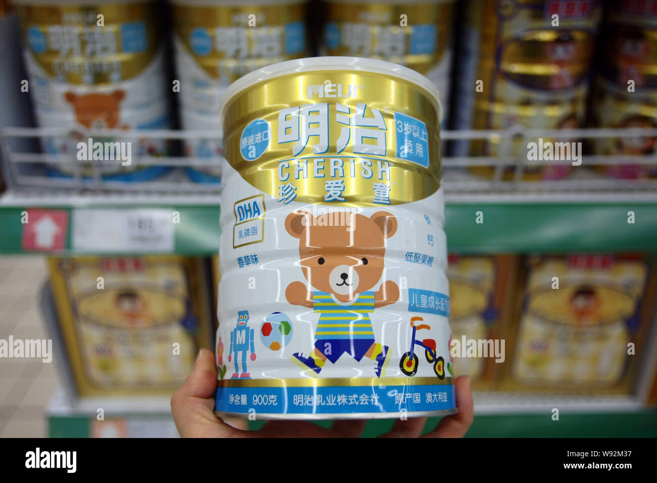 --FILE--A customer buys a tin of Meiji Cherish baby milk powder at a ...