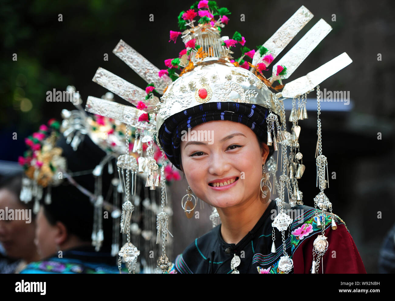 A Chinese woman of Miao ethnic minority dressed in a traditional Miao ...