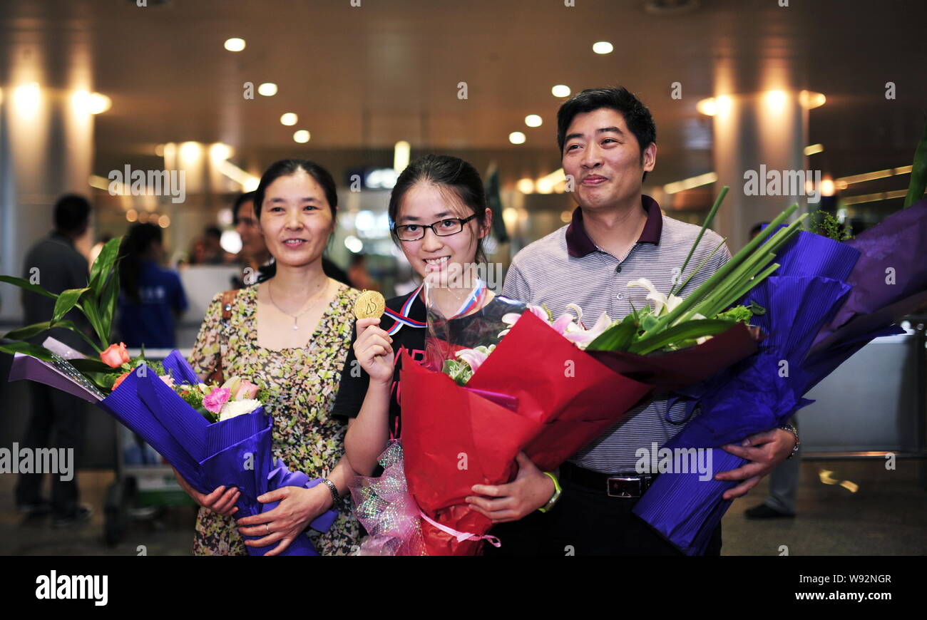 Chinese student Sun Weiwei, center, one of the gold medal winners of the 45th International ...