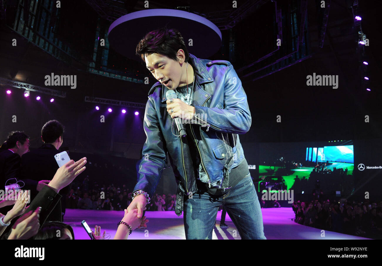 South Korean singer and actor Jeong Ji-hoon, front, better known by his stage name Rain, shakes ...