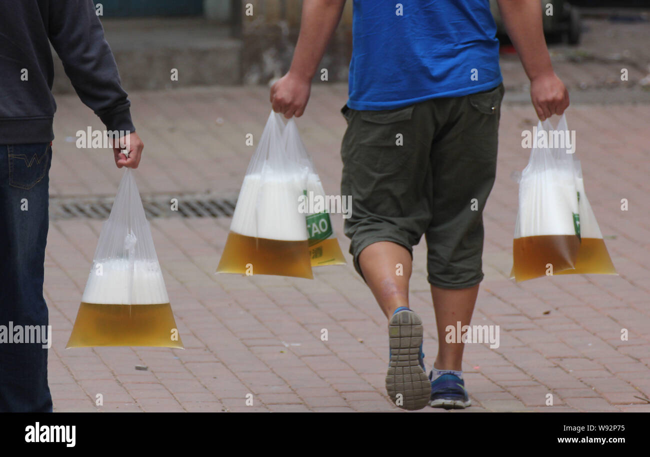 --FILE--Local Chinese residents carry plastic bags filled with draught ...