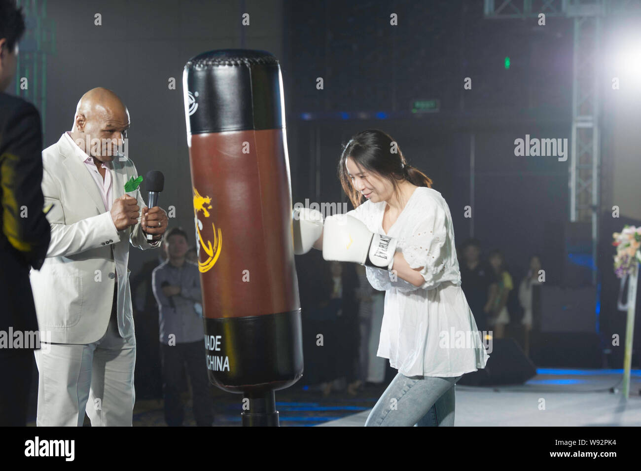 Retired U.S. professional boxer Mike Tyson, left, poses next to a young ...