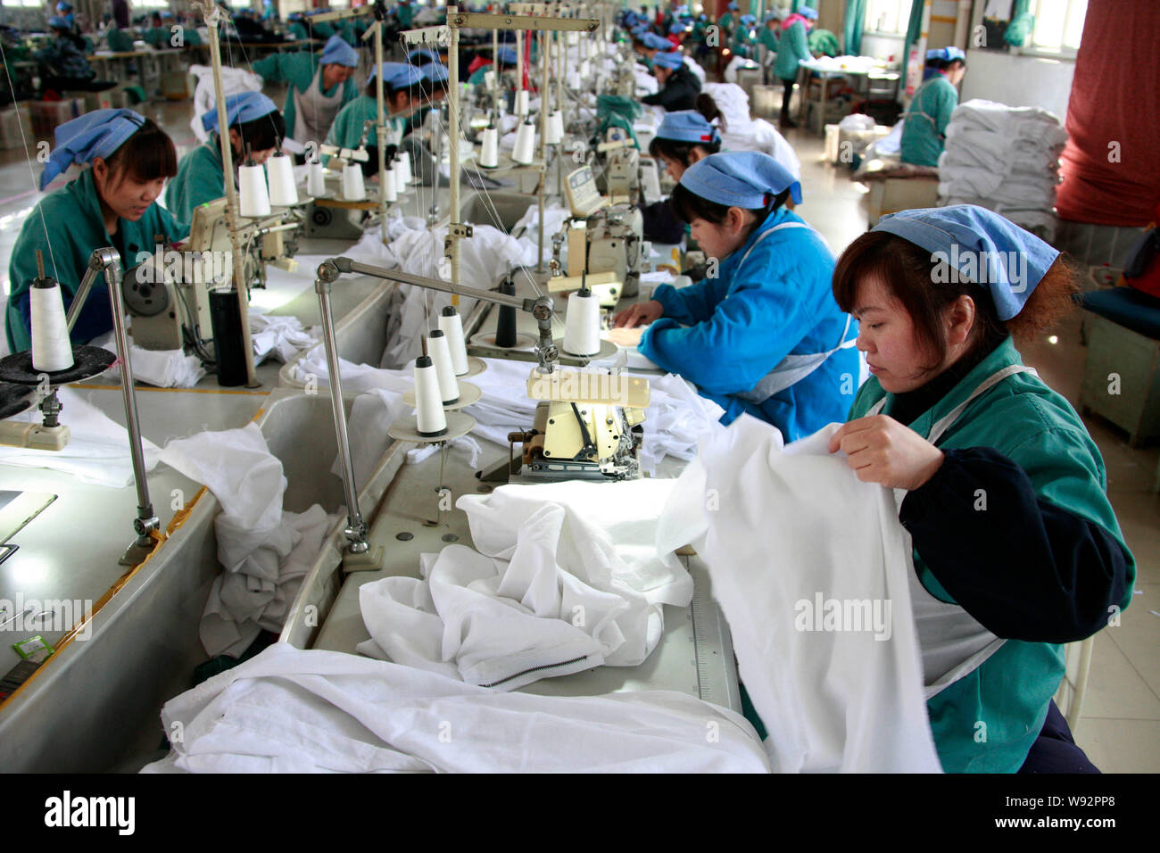 --FILE--Female Chinese workers sew clothes to be exported to southeast Asia countries at a ...