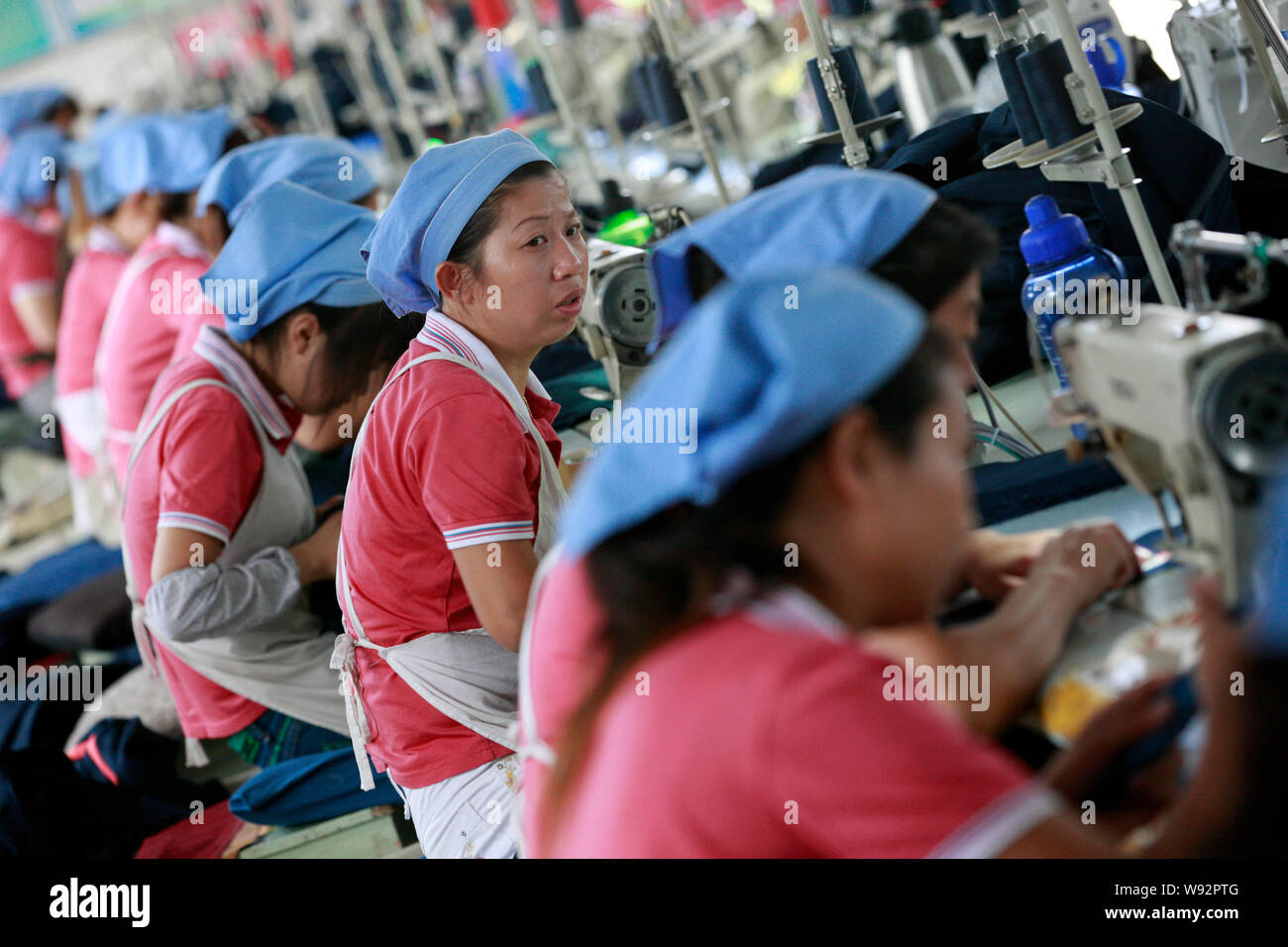 --FILE--Female Chinese workers sew clothes to be exported to Southeast Asia at a garment factory ...