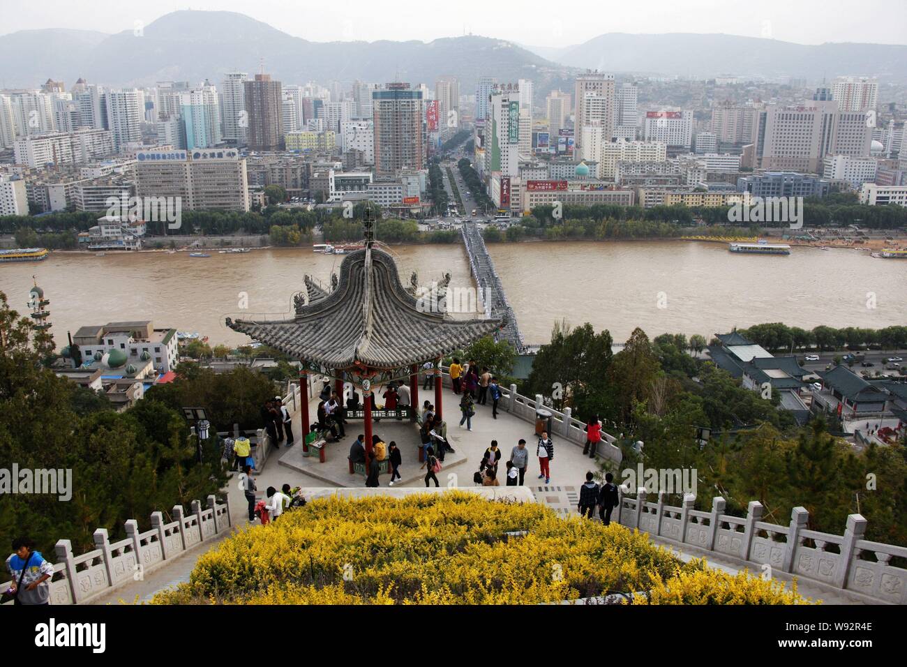 --FILE--Tourists look at the skyline of Lanzhou city with clusters of ...
