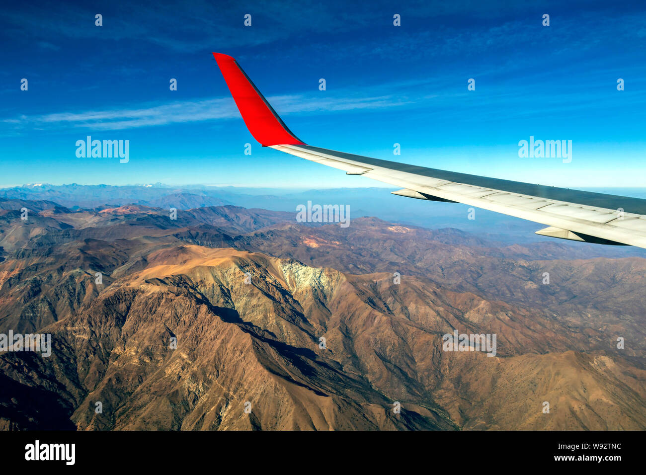 Plane wing above Andean mountain range, aerial view of Andes from the ...
