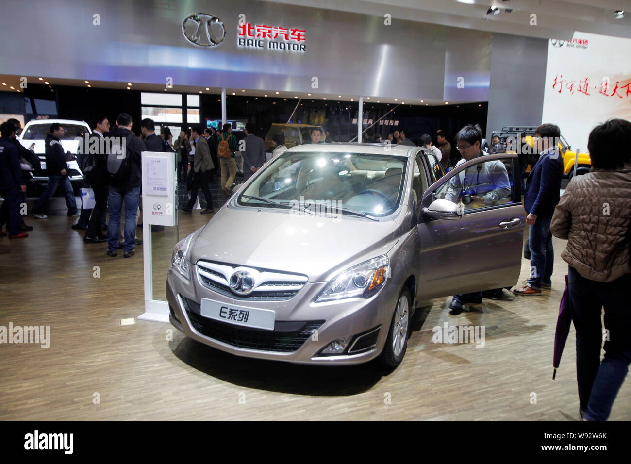 --FILE--Visitors look at a car at the stand of BAIC Group, also known ...
