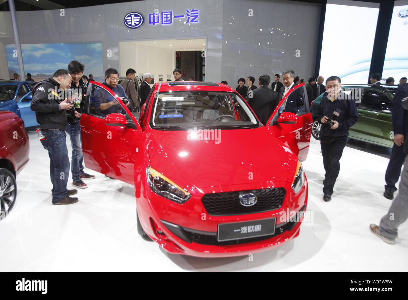 Visitors look at an Oley car of FAW during the 15th Shanghai ...