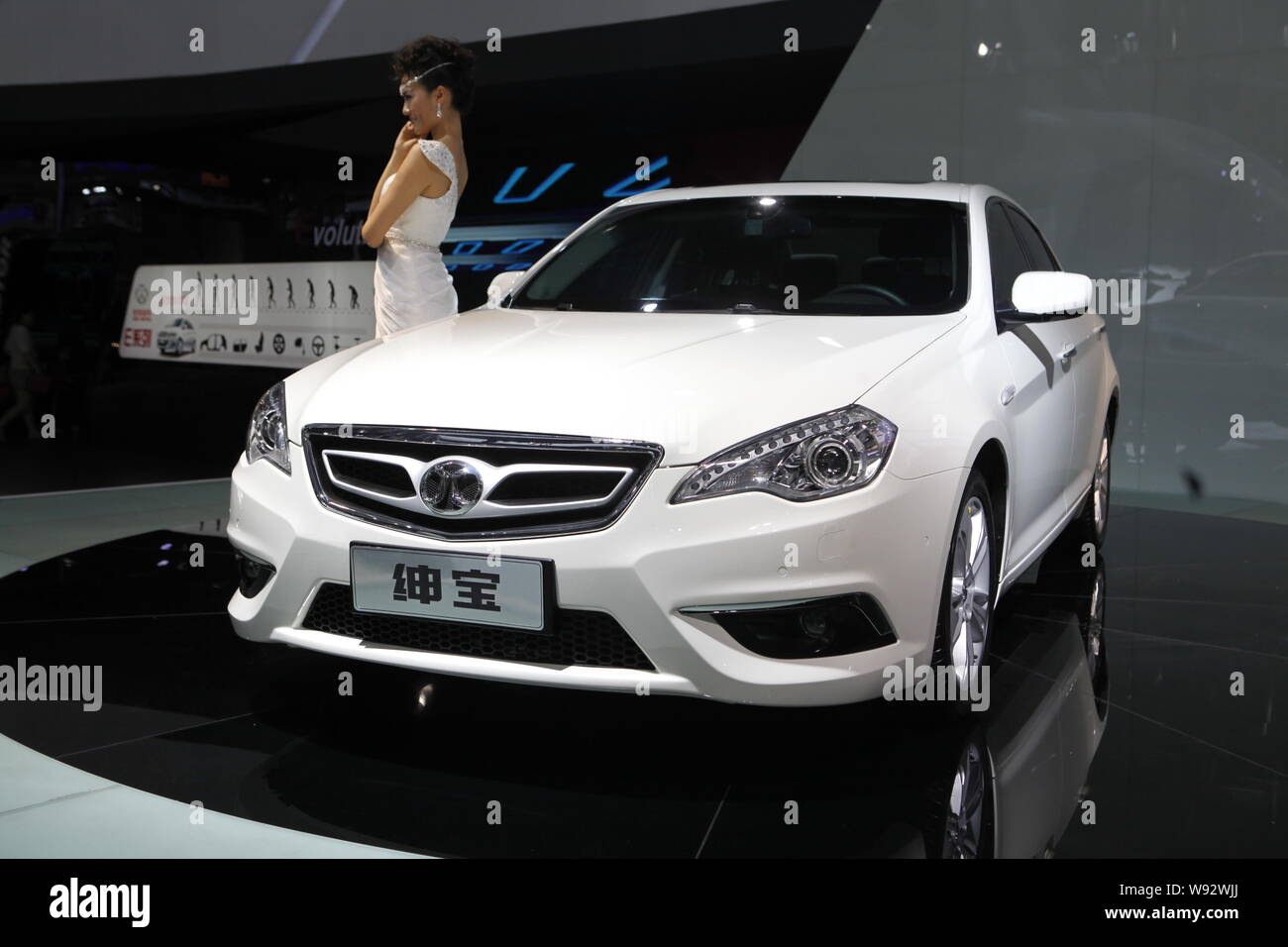 --FILE--A model poses with a Senova car of BAIC Motor during the 10th ...