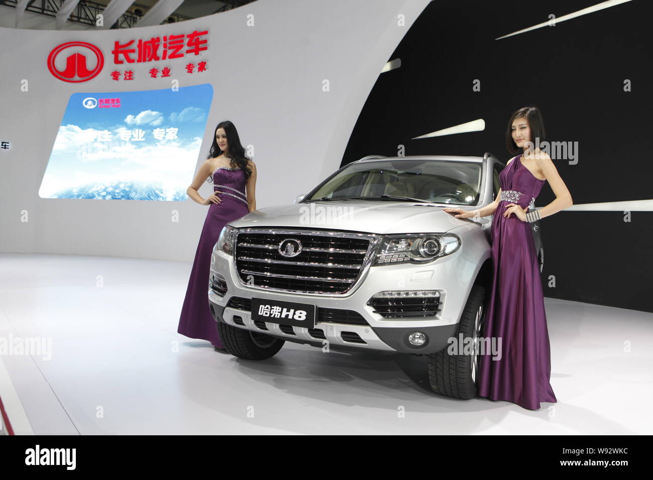 --FILE--Models pose with a Haval H8 SUV of Great Wall Motors during an ...
