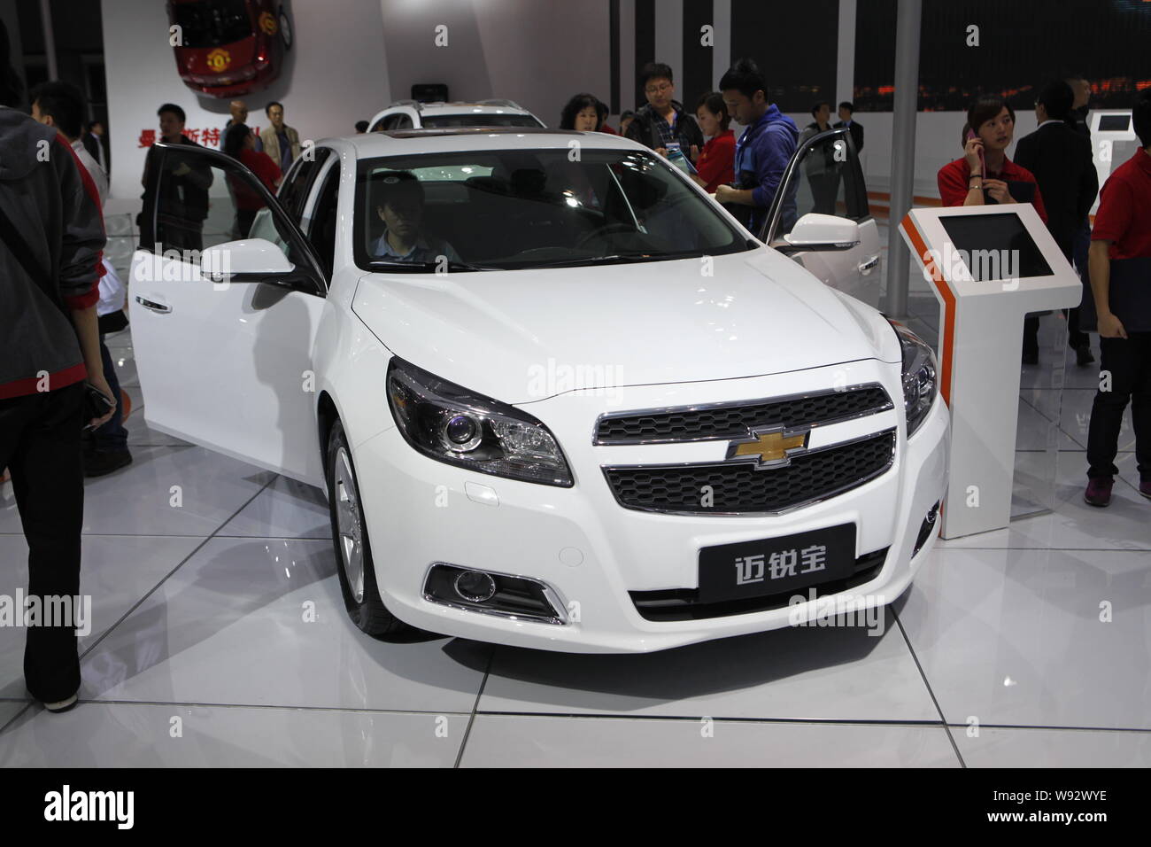 --FILE--Visitors look at a Chevrolet Malibu of Shanghai GM, a joint ...