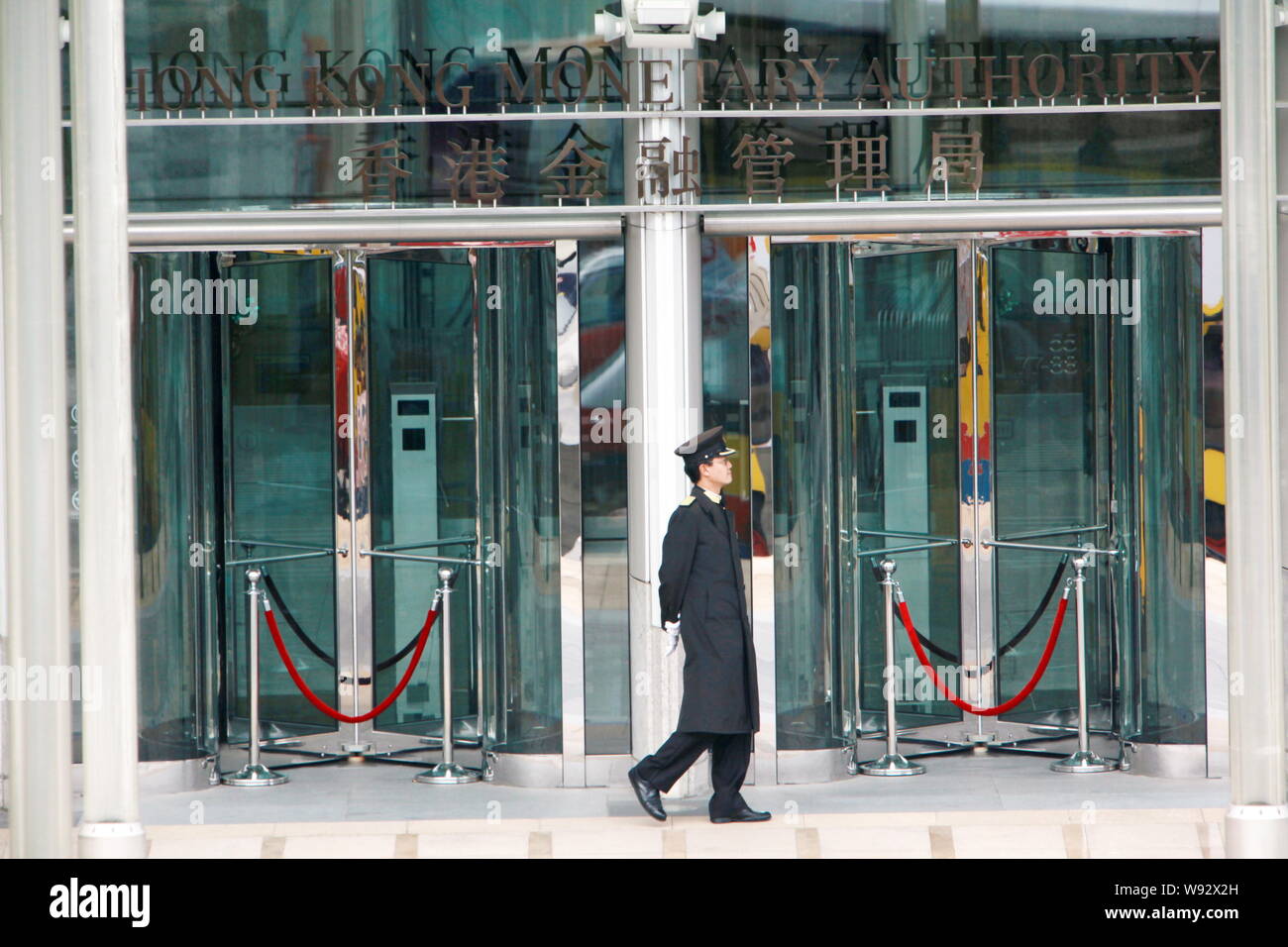 --FILE--A security guard walks past the closed doors at the Hong Kong ...