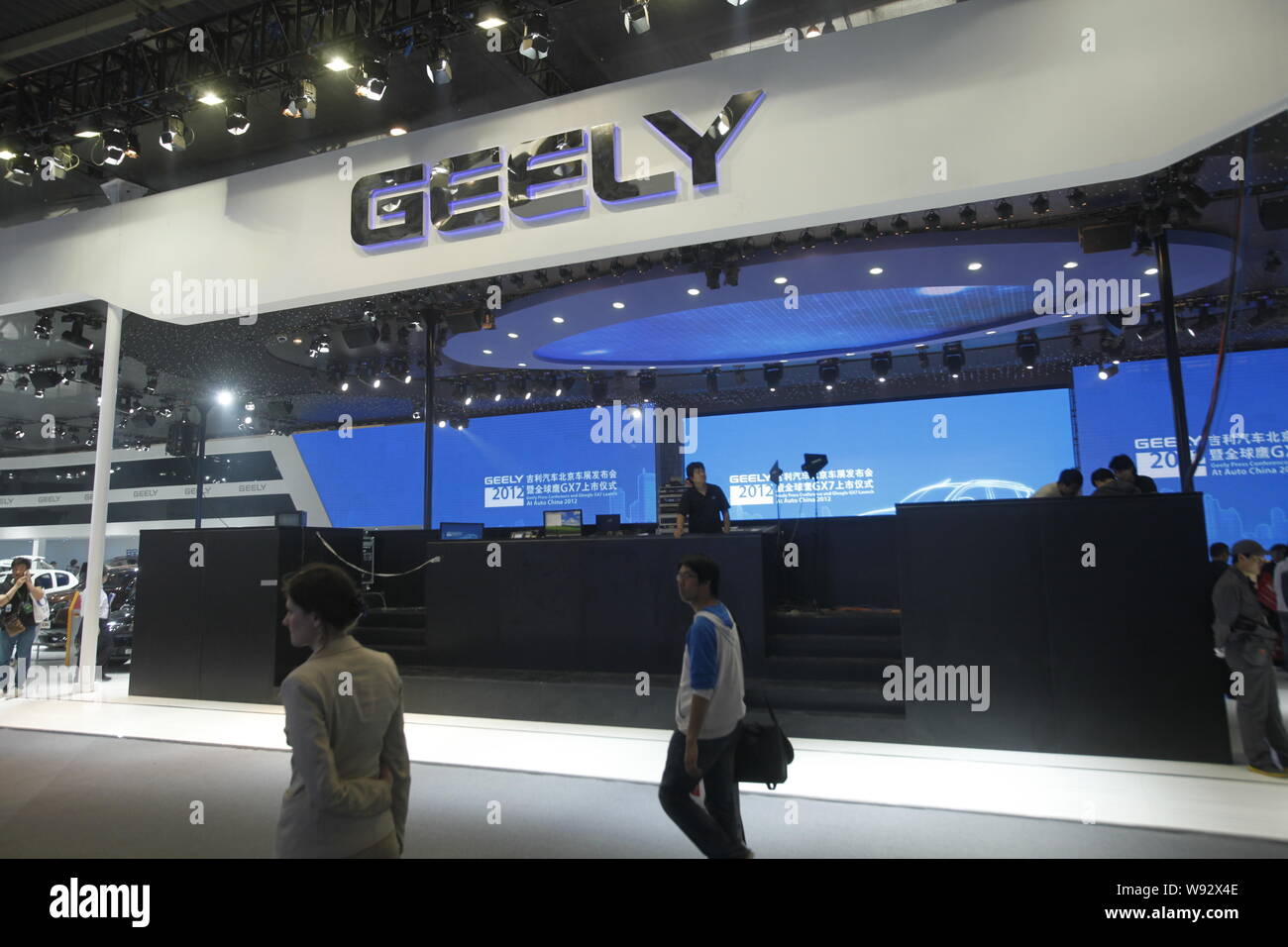 --FILE--Visitors walk past the stand of Geely during the 12th Beijing ...