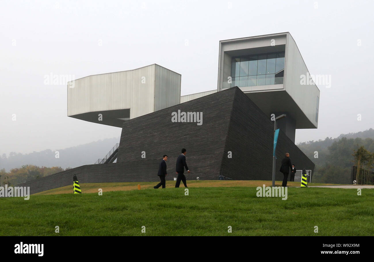 Employees walk past the Sifang Art Museum designed by New York ...
