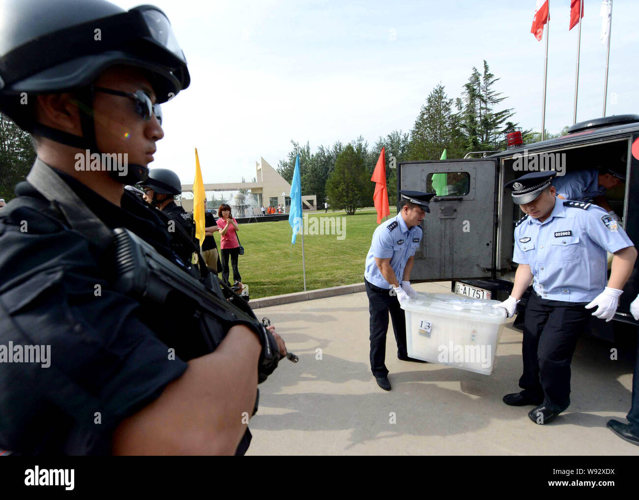 Armed Chinese special policemen stand guard as other police officers ...