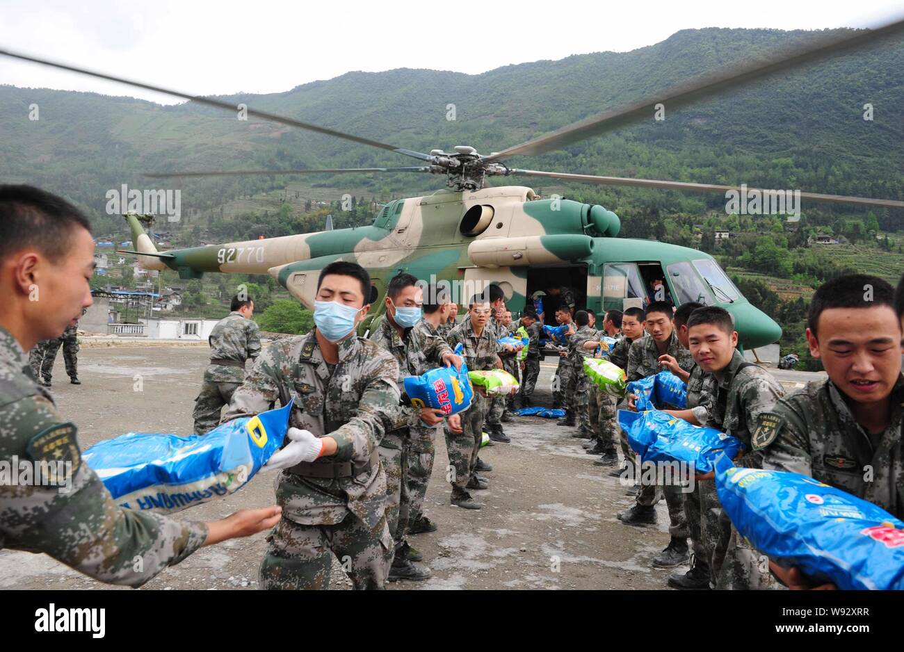 Chinese PLA (Peoples Liberation Army) soldiers unload relief goods from ...