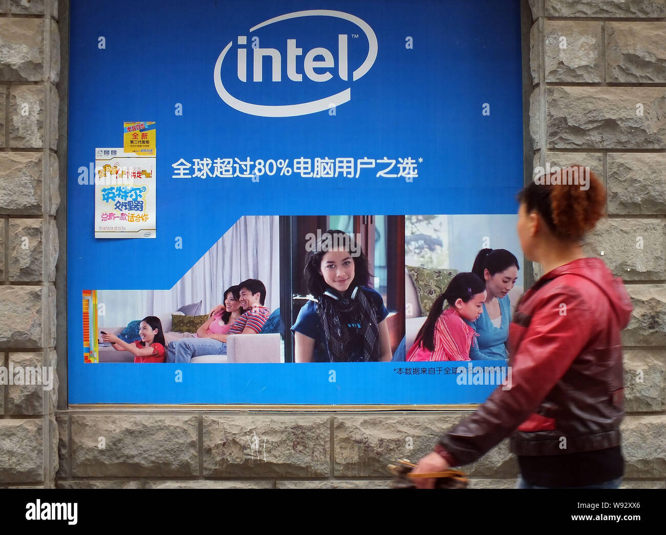 --FILE--A pedestrian walks past an advertisement of Intel in Yichang ...