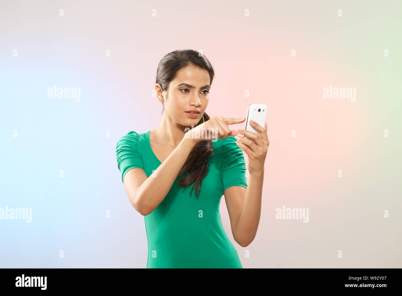 Young woman text messaging on a mobile phone Stock Photo - Alamy