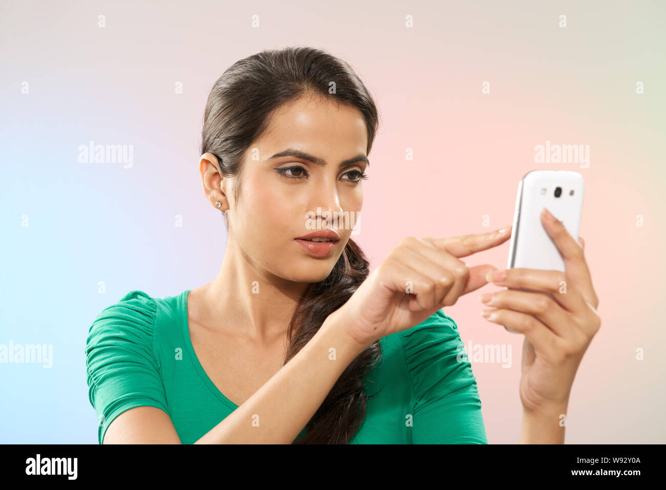 Young woman text messaging on a mobile phone Stock Photo - Alamy
