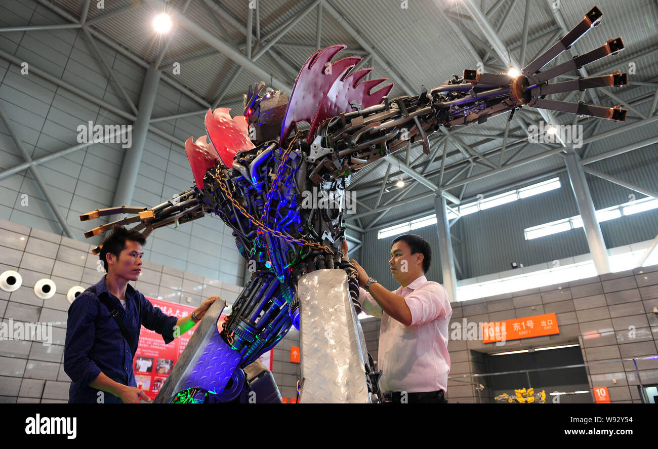 Chinese fans examine and test a robot made from auto scraps in the ...